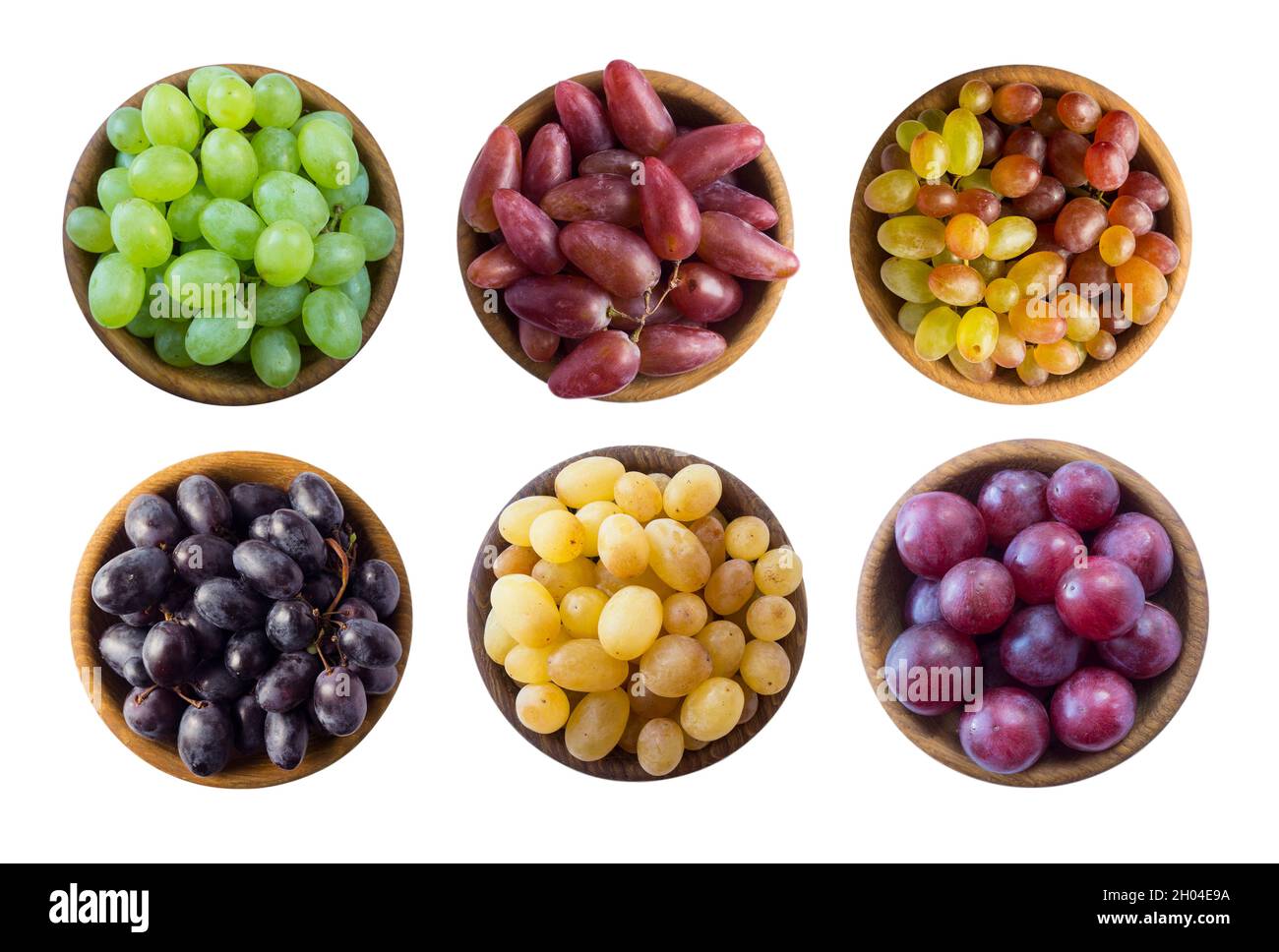 Grapes in a wooden bowl isolated on white background. Yellow, blue ...