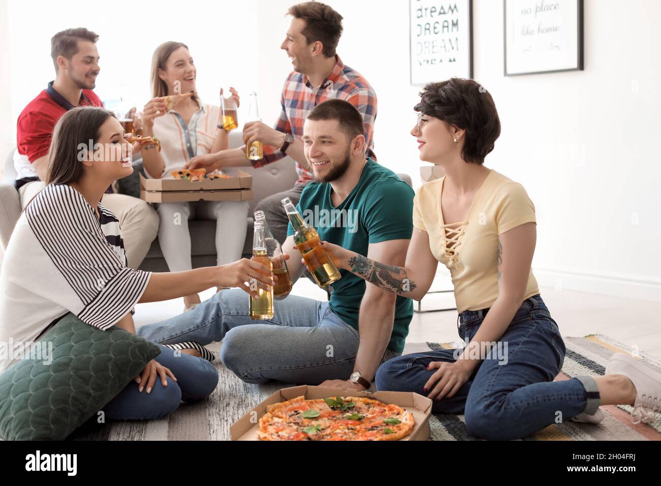 Young people having fun party with delicious pizza indoors Stock Photo ...