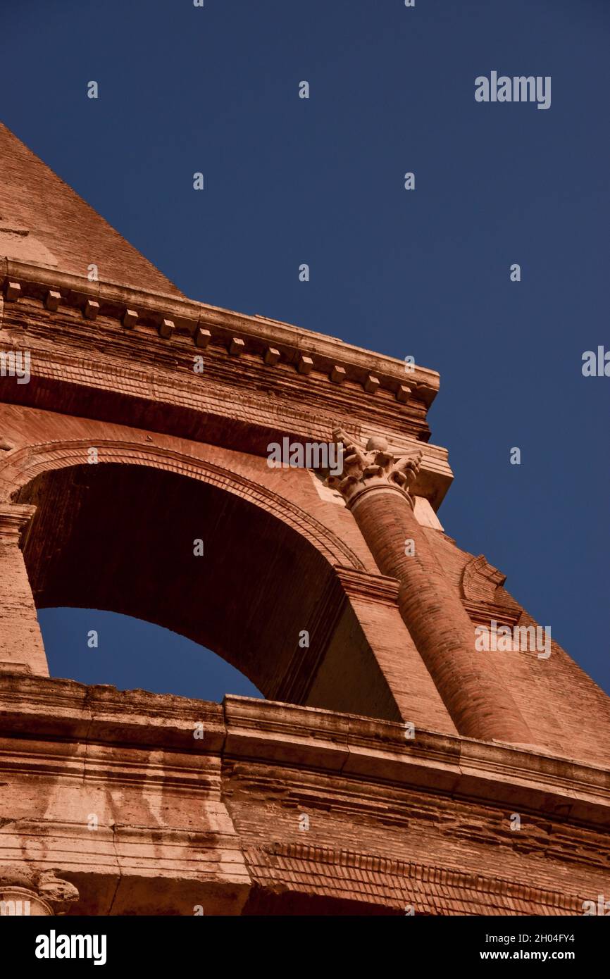 Vertical low angle of an old monument against blue sky in Rome, Italy ...