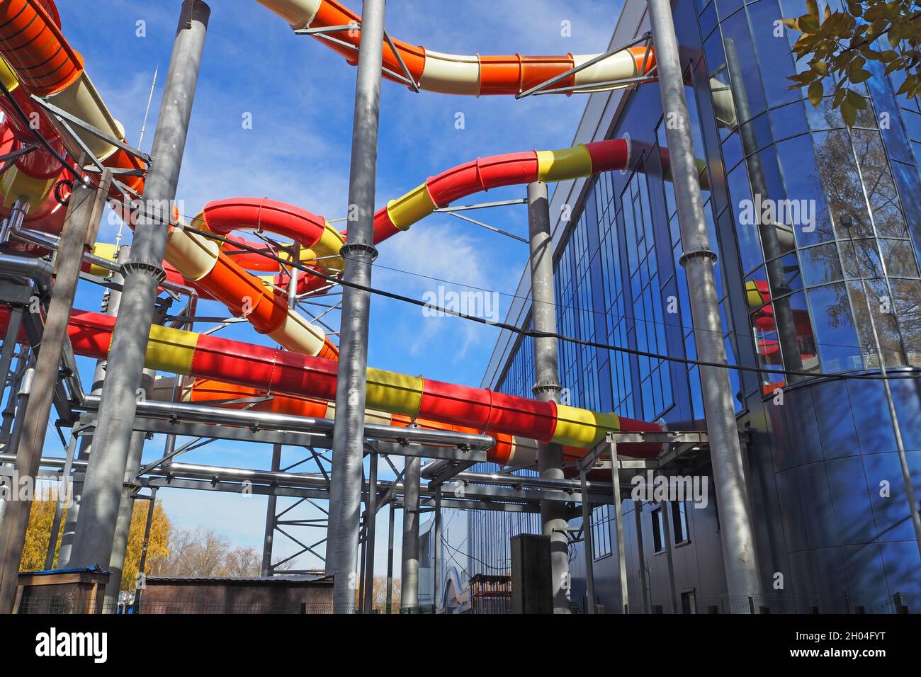 Bright colored water slides in the water park against the blue sky ...