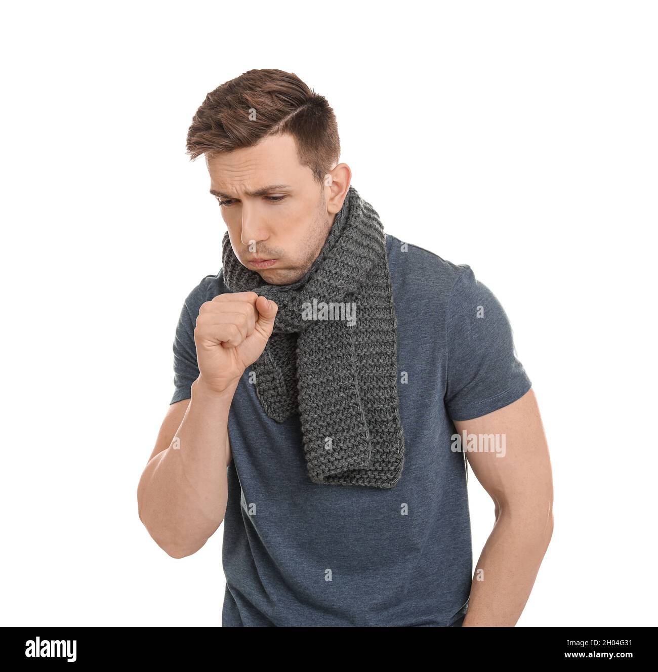 Young man coughing on white background Stock Photo - Alamy