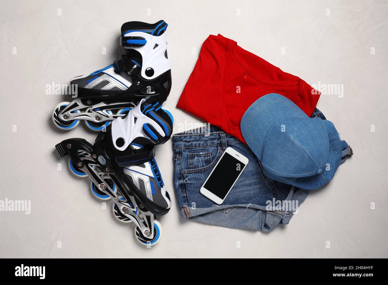 Flat lay composition with inline roller skates on light background ...