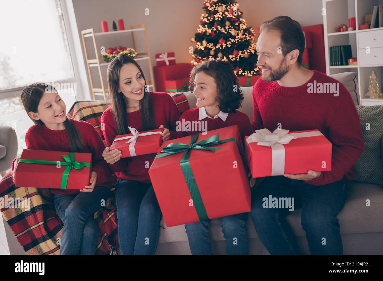 Photo of attractive cute dad mom two children dressed red sweaters ...