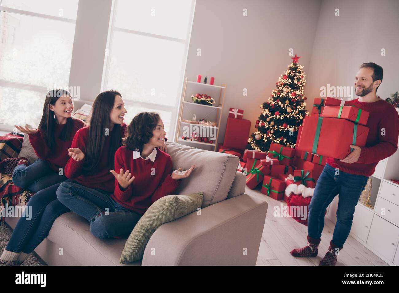 Photo of charming excited dad mom two children dressed red sweaters ...