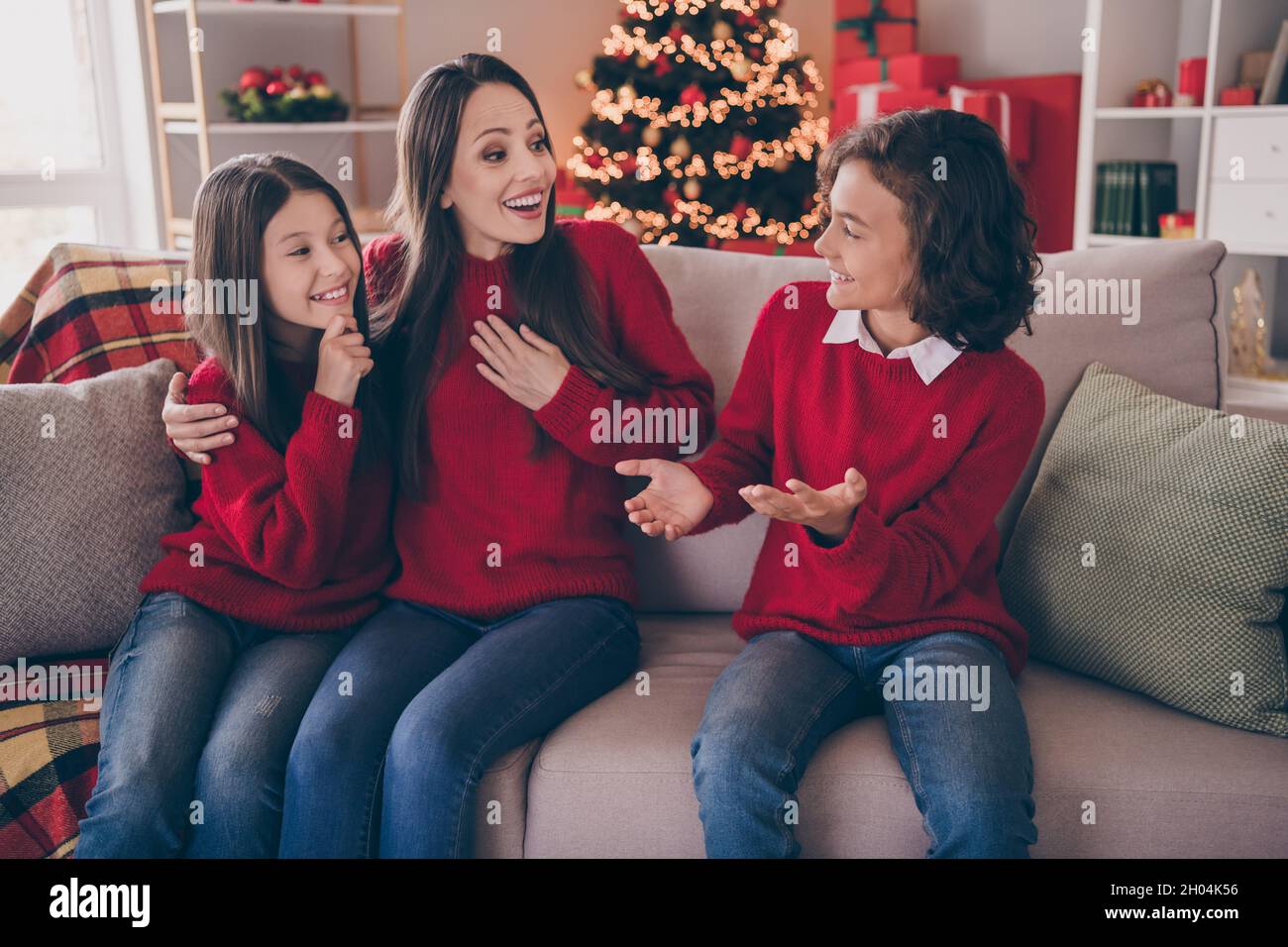 Photo of cute funny mom son daughter wear red pullovers smiling talking ...