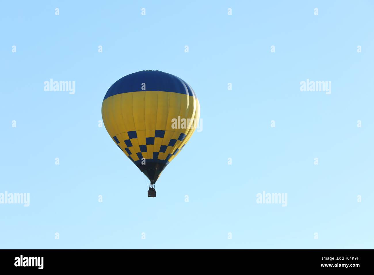 Colorful hot air balloon flying in blue sky. Space for text Stock Photo ...
