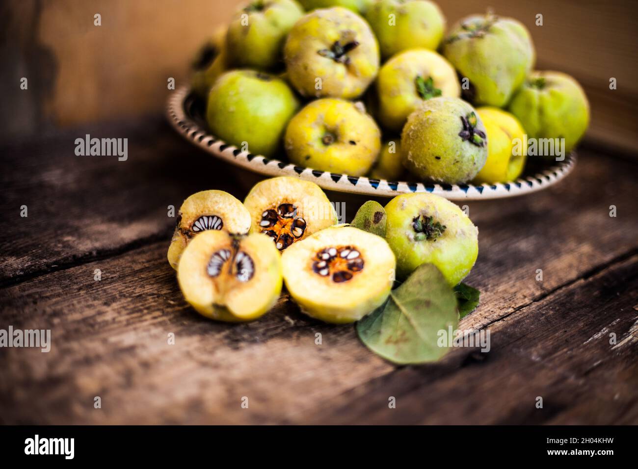 Quince fruits on a wooden background. Harvest of autumn fruits. Yellow ...