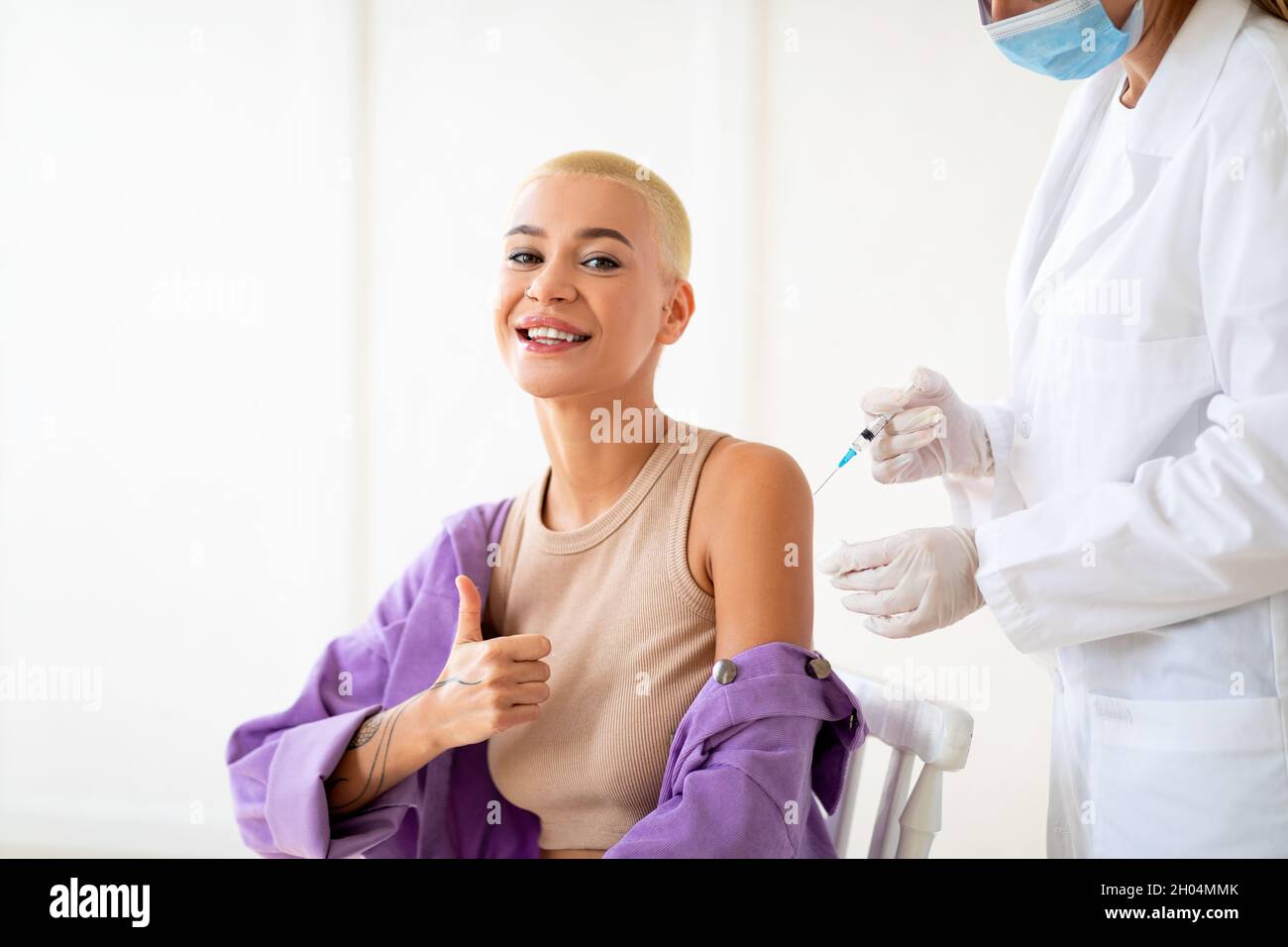 Happy millennial lady approving of covid-19 vaccination, gesturing ...