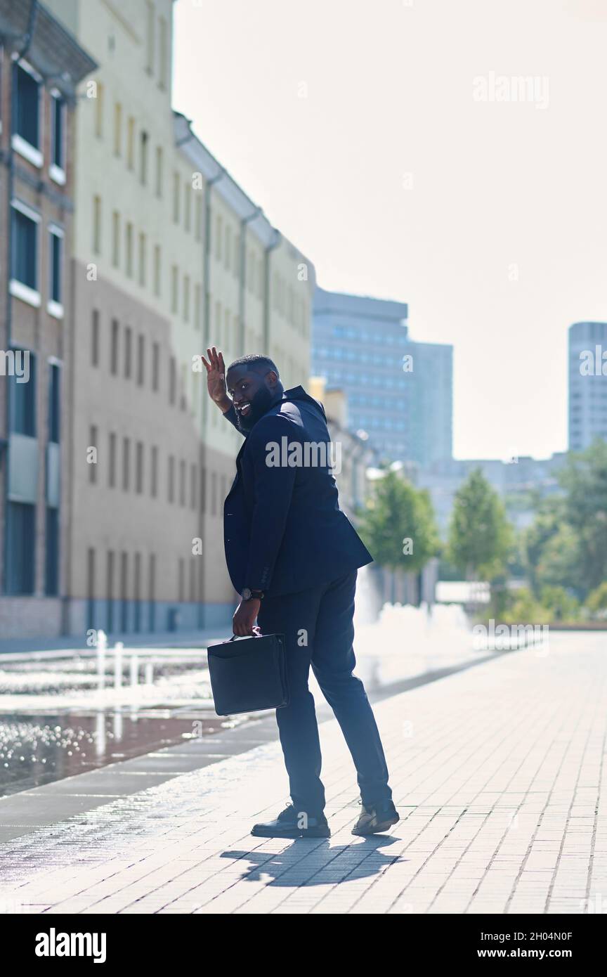 A tall dark-skinned man in a suit in the street Stock Photo - Alamy