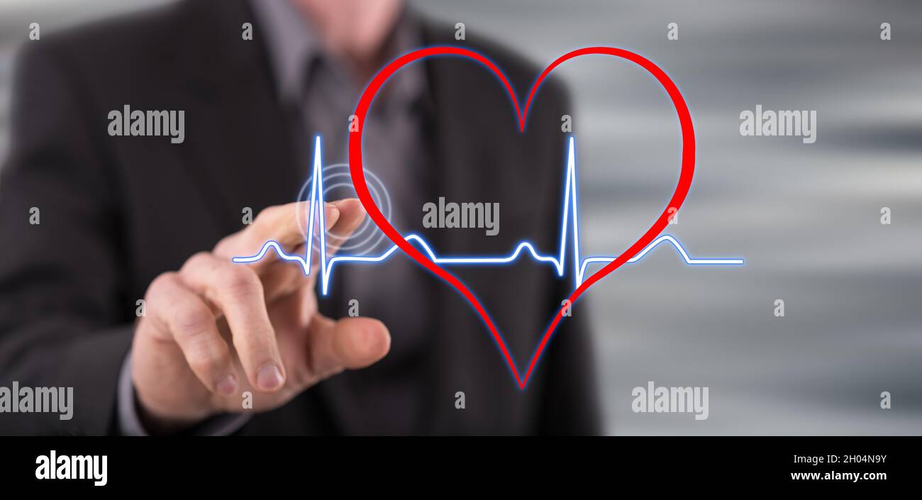Man touching a heart beats graph on a touch screen with his finger ...