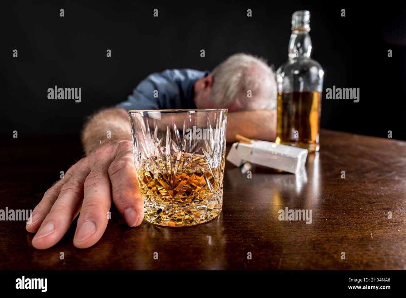 Drunk man slumped on table after alcohol abuse Stock Photo - Alamy