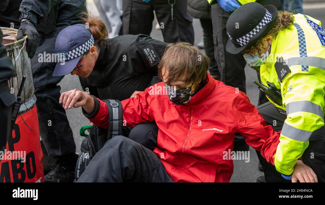 London, UK. 11th Oct, 2021. Greenpeace activists block Whitehall ...