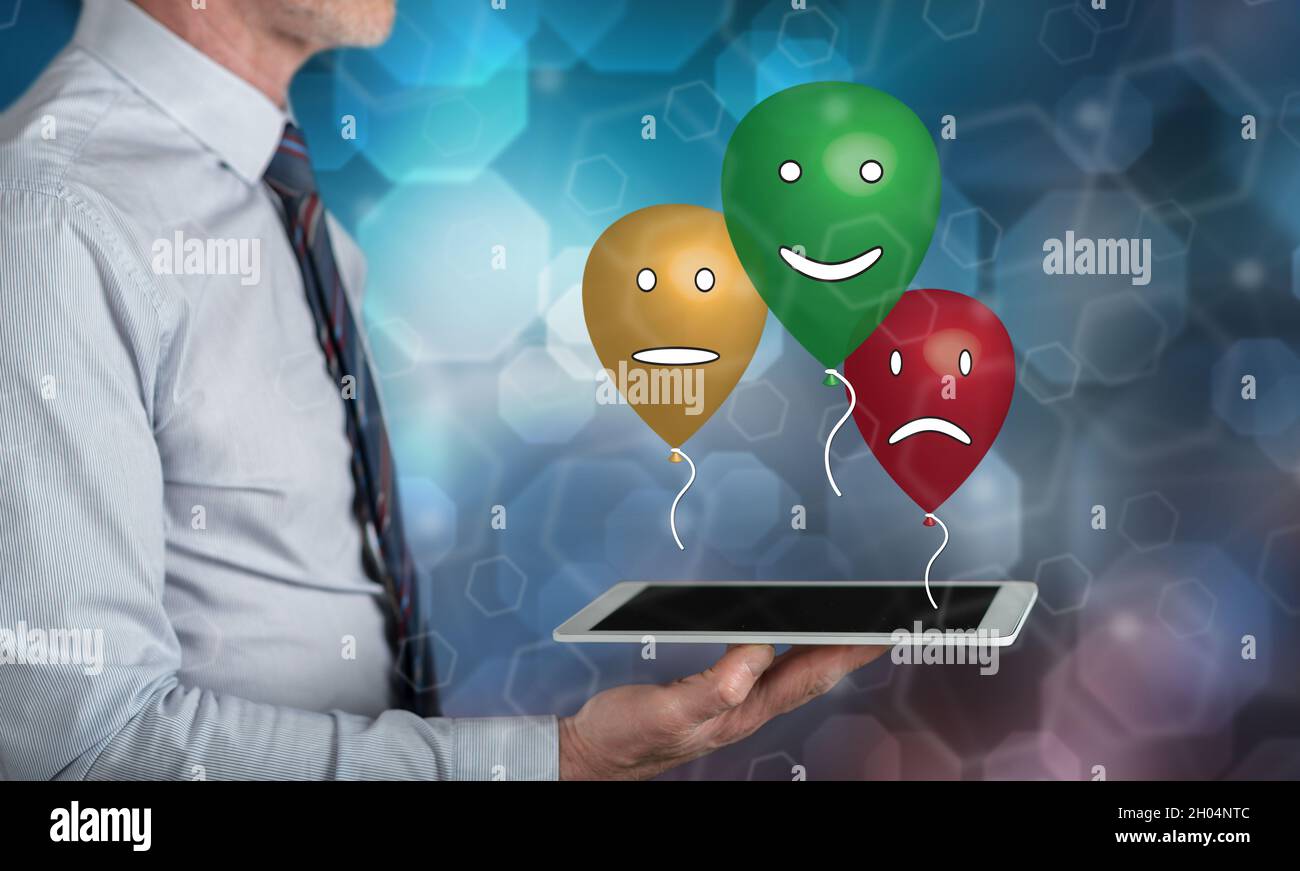 Customer satisfaction concept above a tablet held by a man Stock Photo ...
