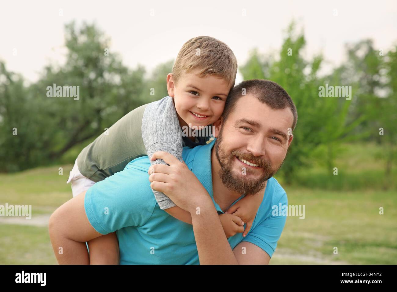 Man with his child outdoors. Happy family Stock Photo - Alamy