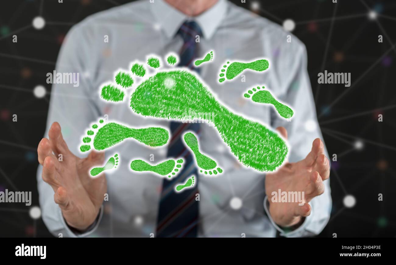 Carbon footprint concept between hands of a man in background Stock ...