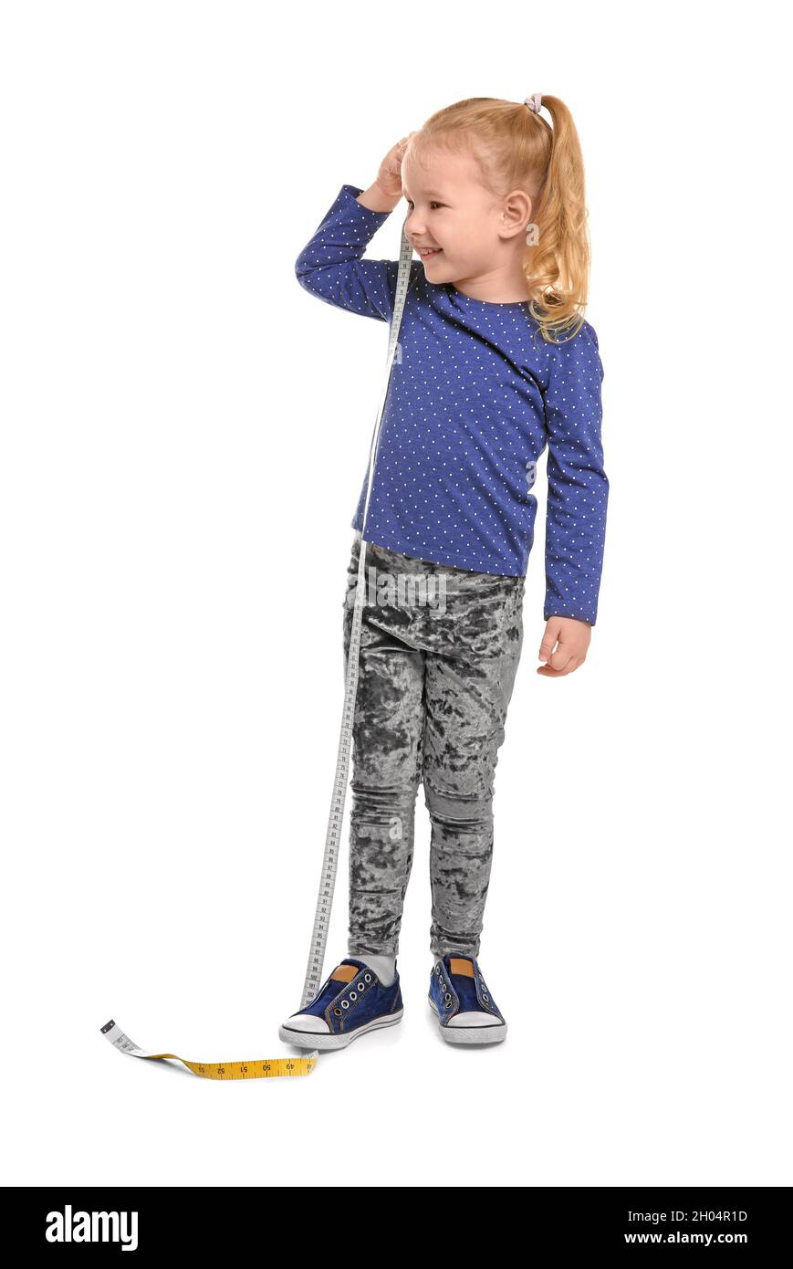 Little girl measuring her height on white background Stock Photo - Alamy