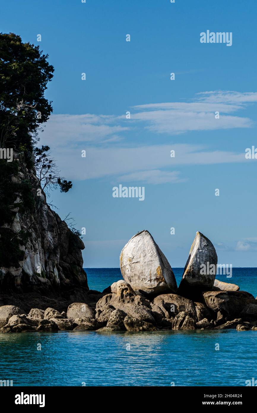 Vertical shot of the Split Apple Rock by the sea in New Zealand Stock ...
