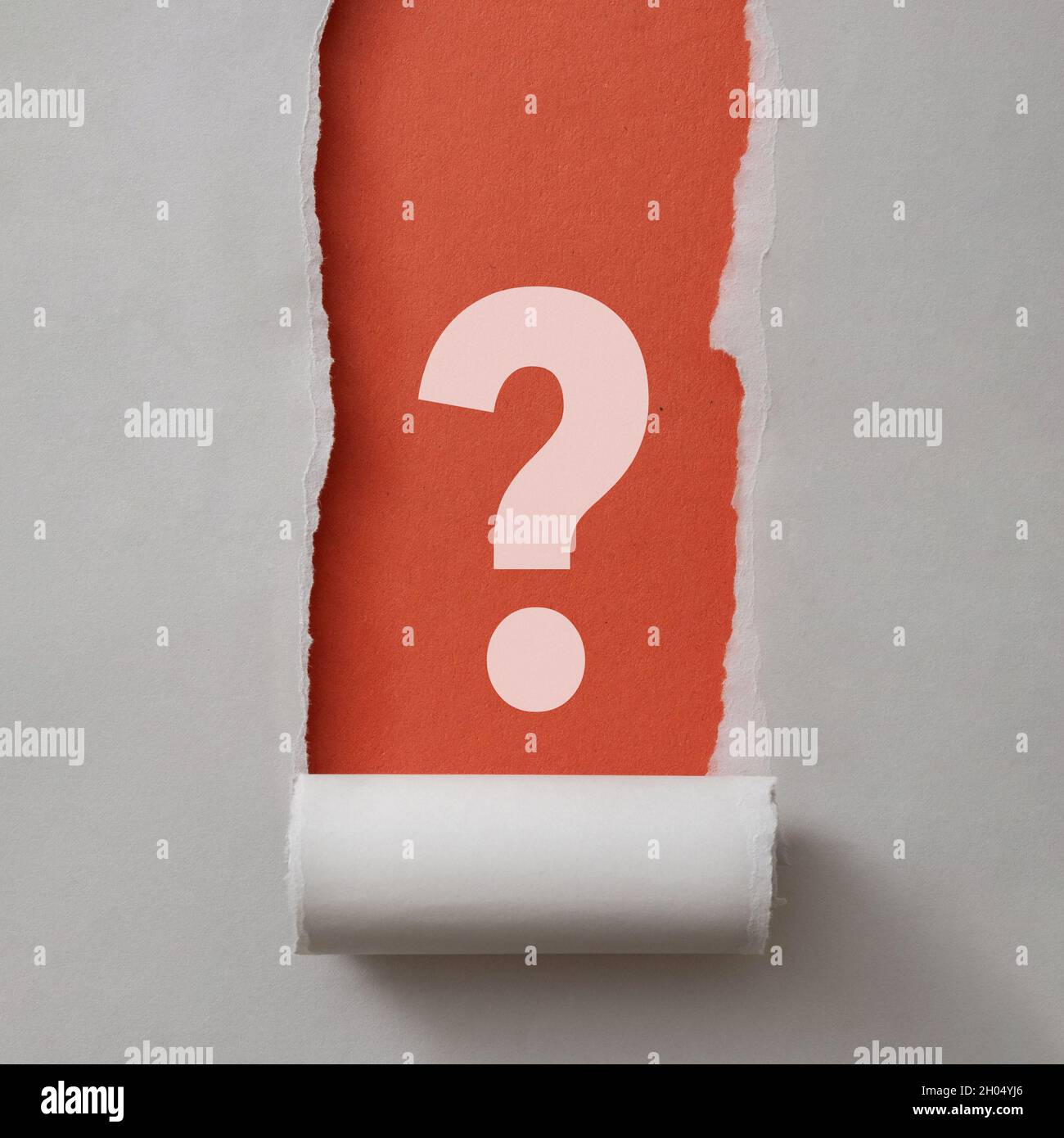 Bold white question mark framed by ripped grey paper neatly rolled to ...