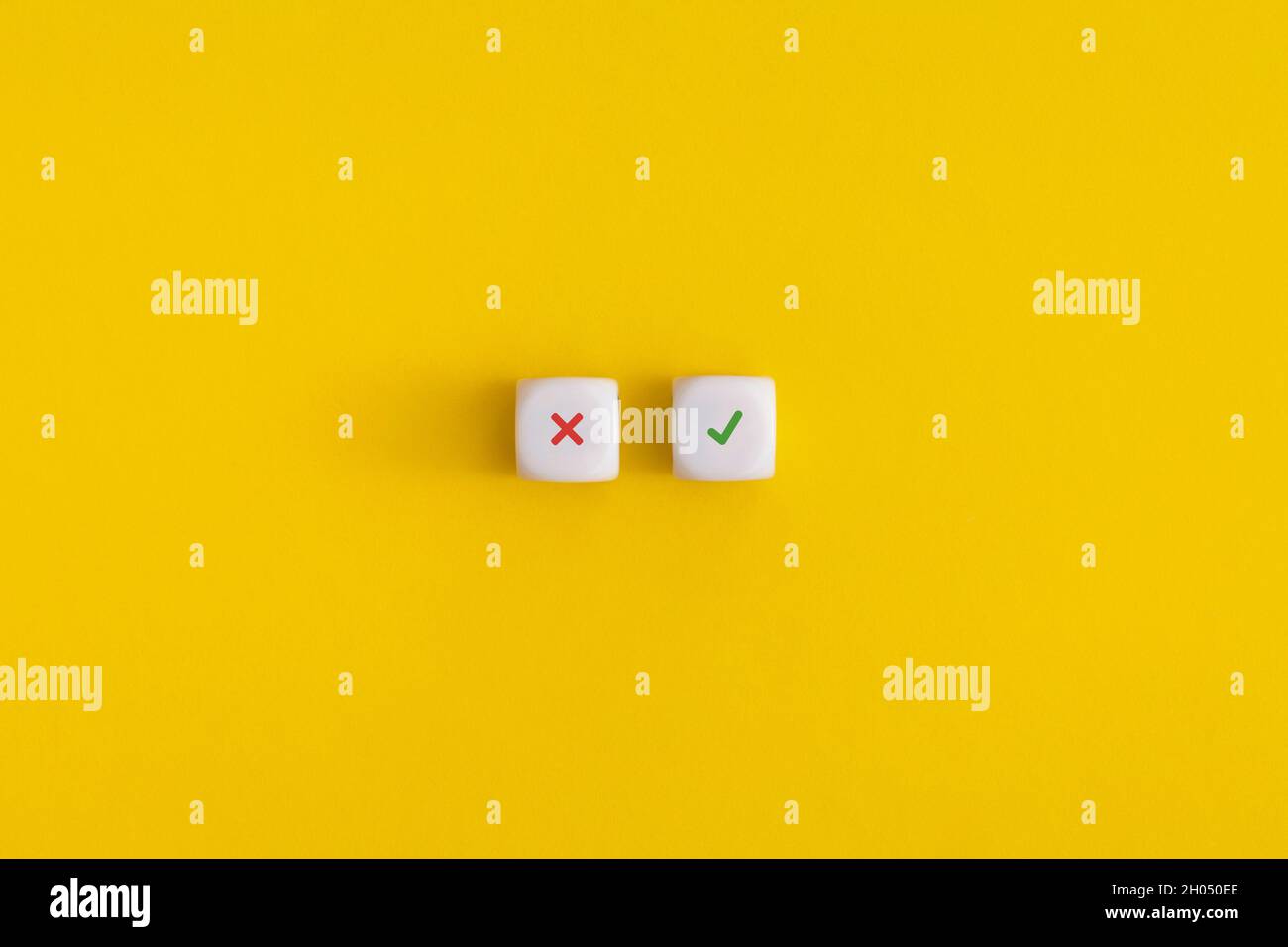 Cross and check mark on a white cubes on yellow background. Approving ...