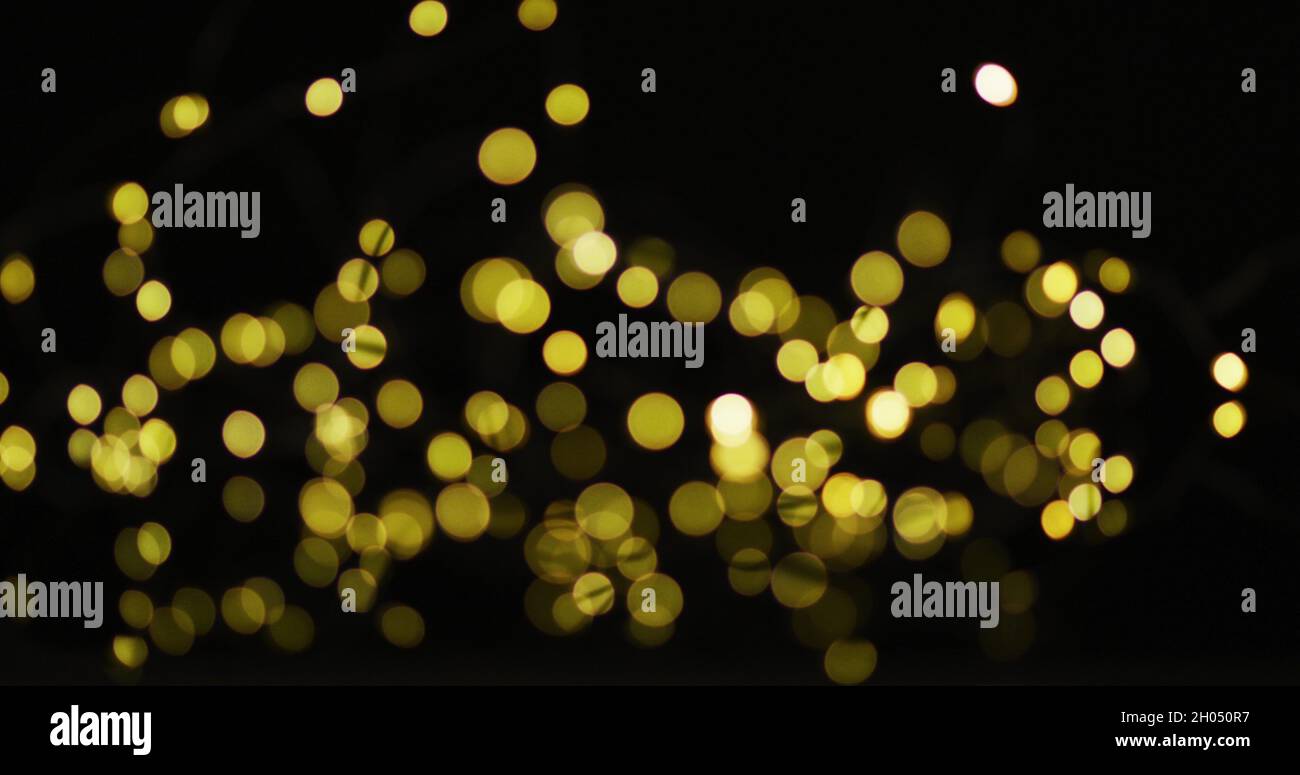 Multiple yellow fairy lights glowing on black background Stock Photo ...