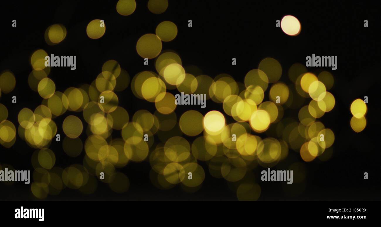 Multiple yellow fairy lights glowing on black background Stock Photo ...