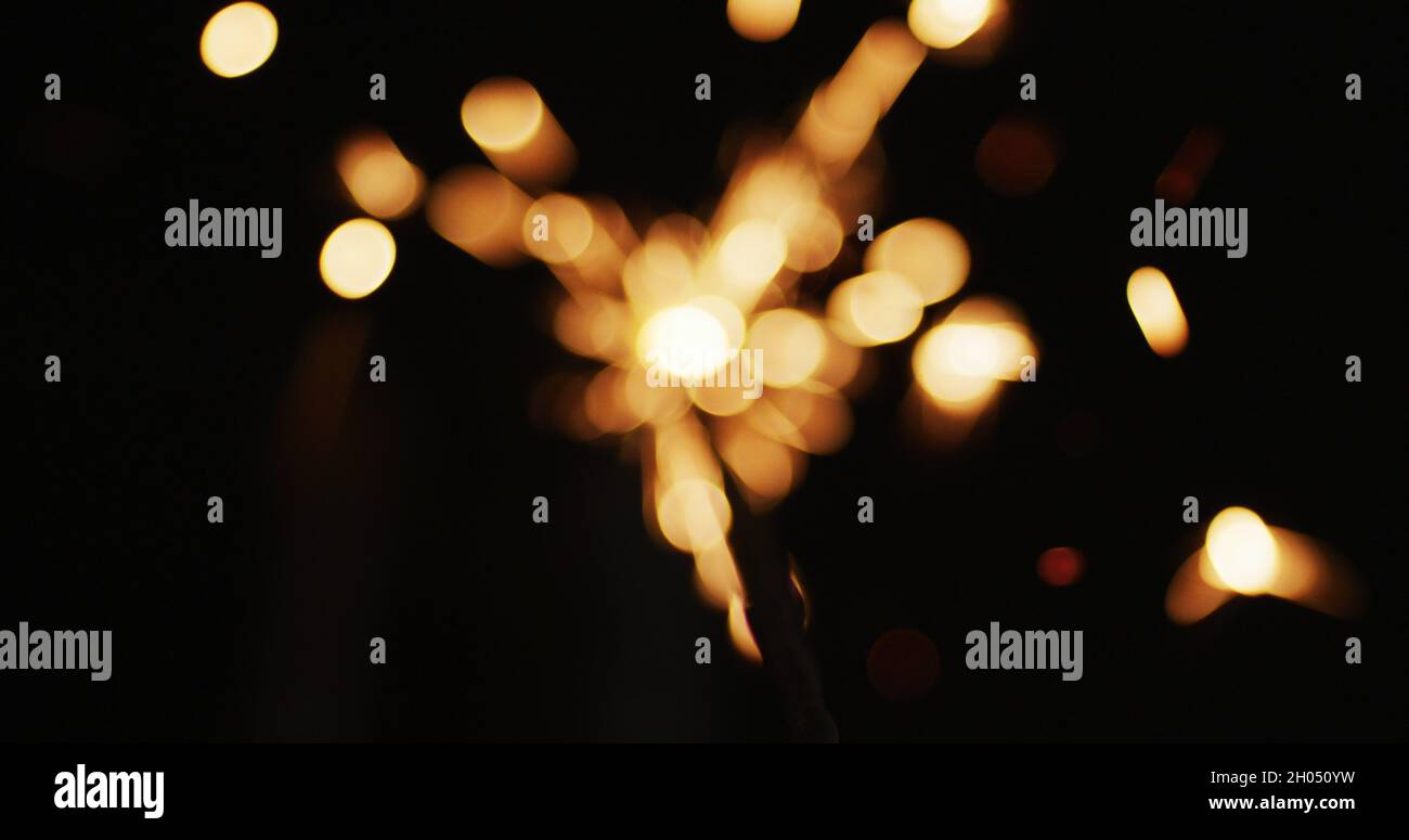 Out of focus party sparkler sparkling on black background Stock Photo ...