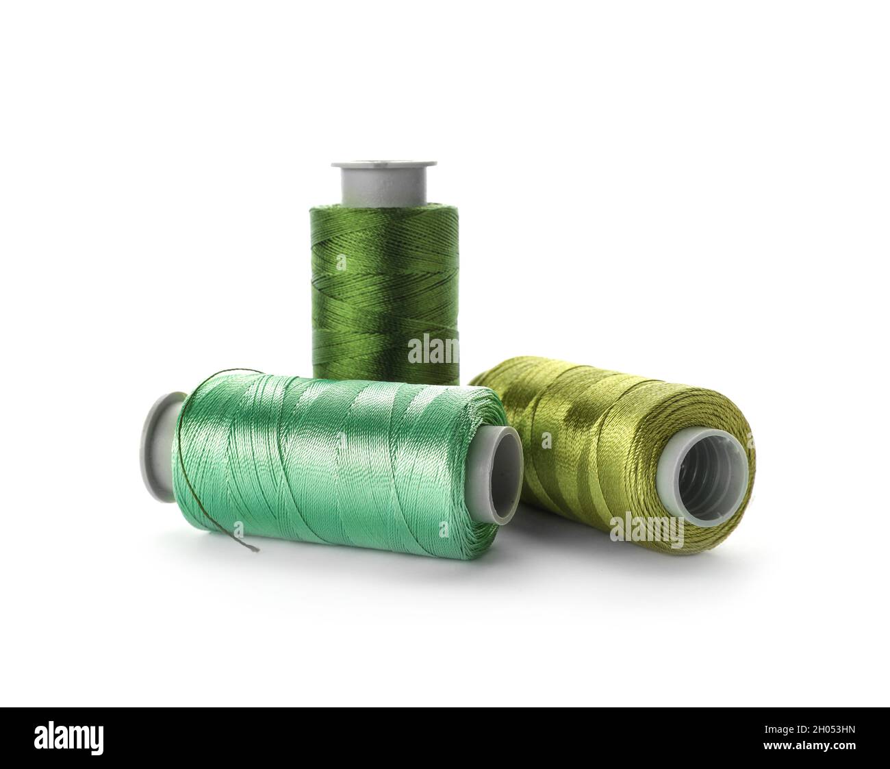 Color sewing threads on white background Stock Photo - Alamy