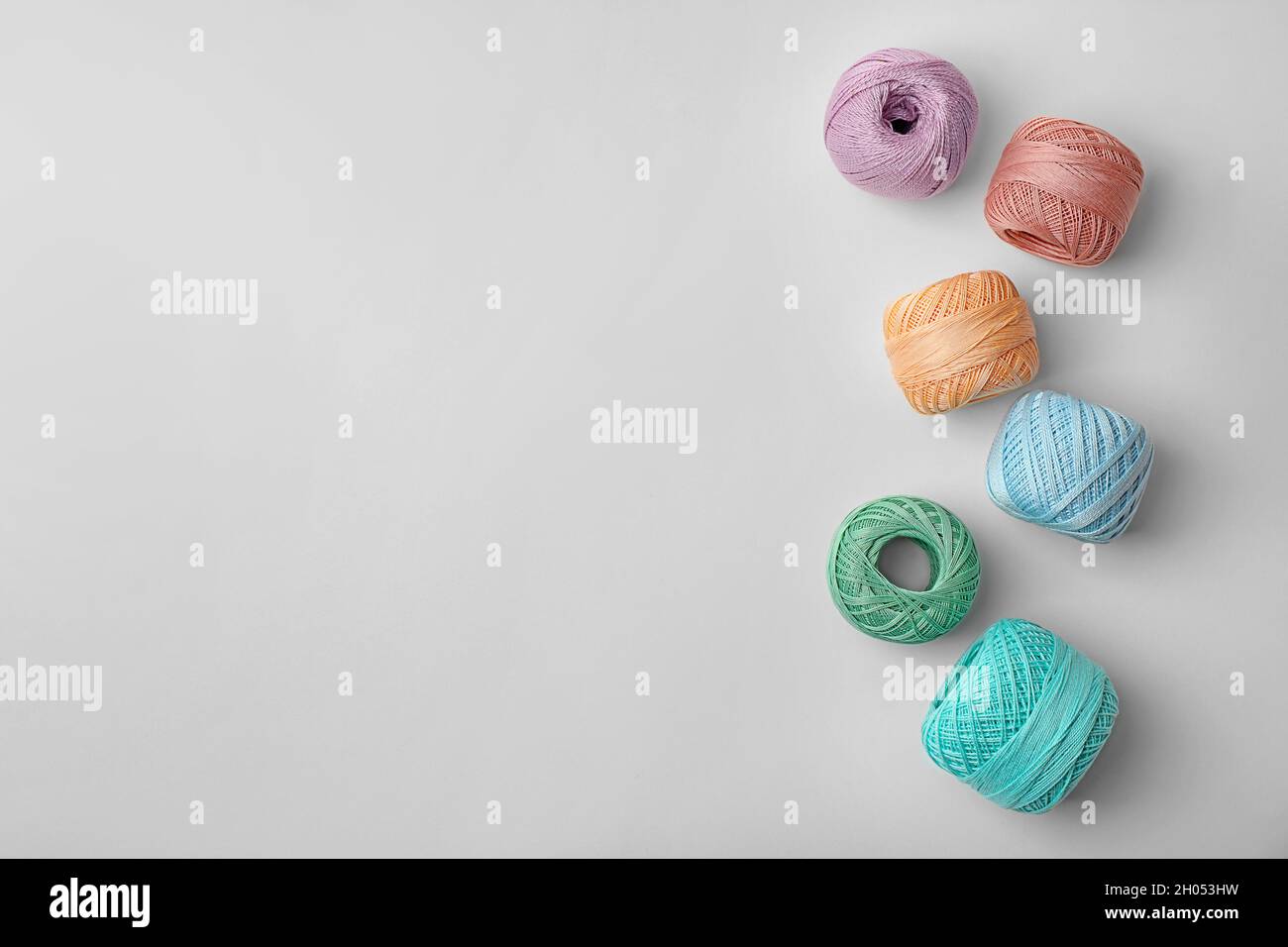 Color sewing threads on white background Stock Photo - Alamy