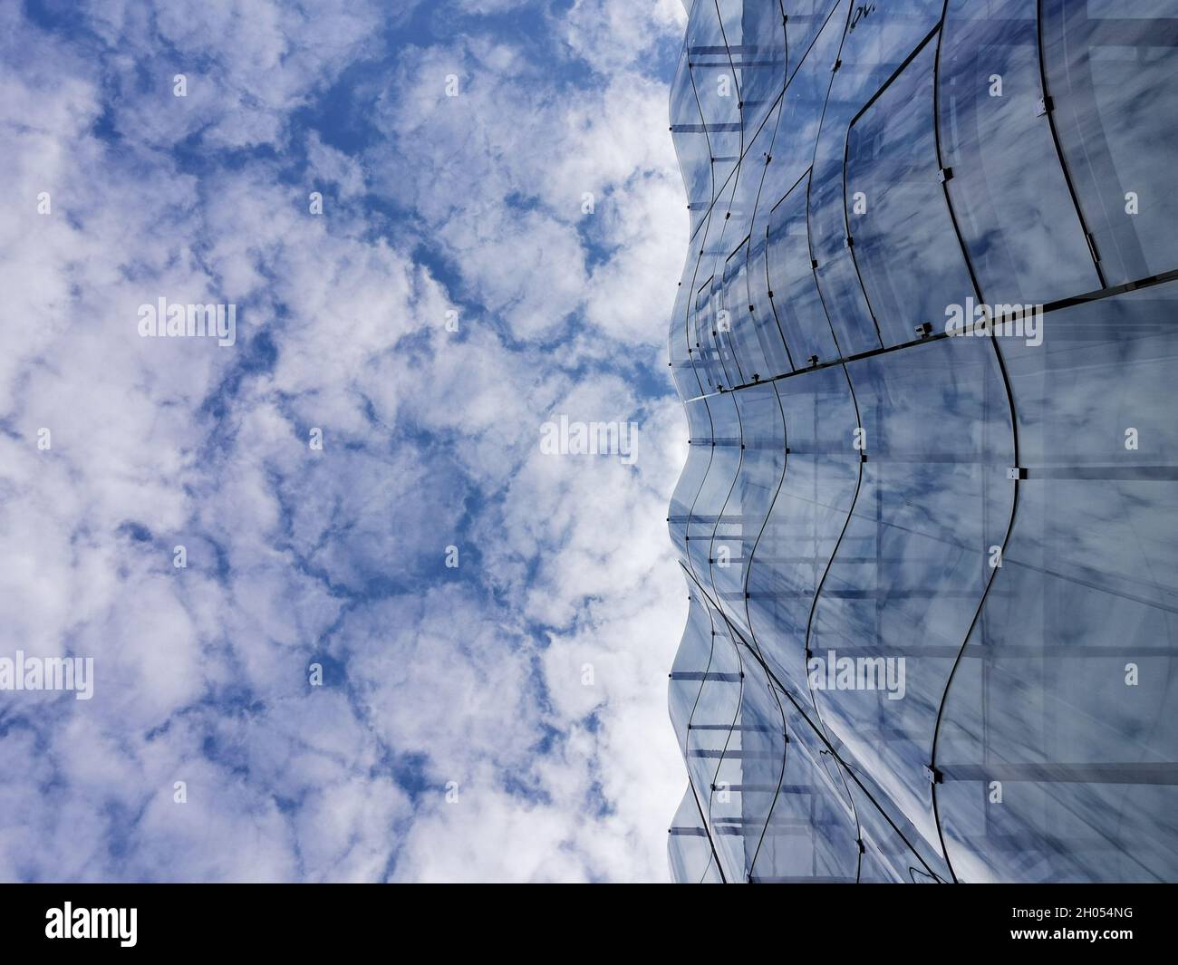 Detail of the wavy glass curtain wall facade of a nice modern building ...