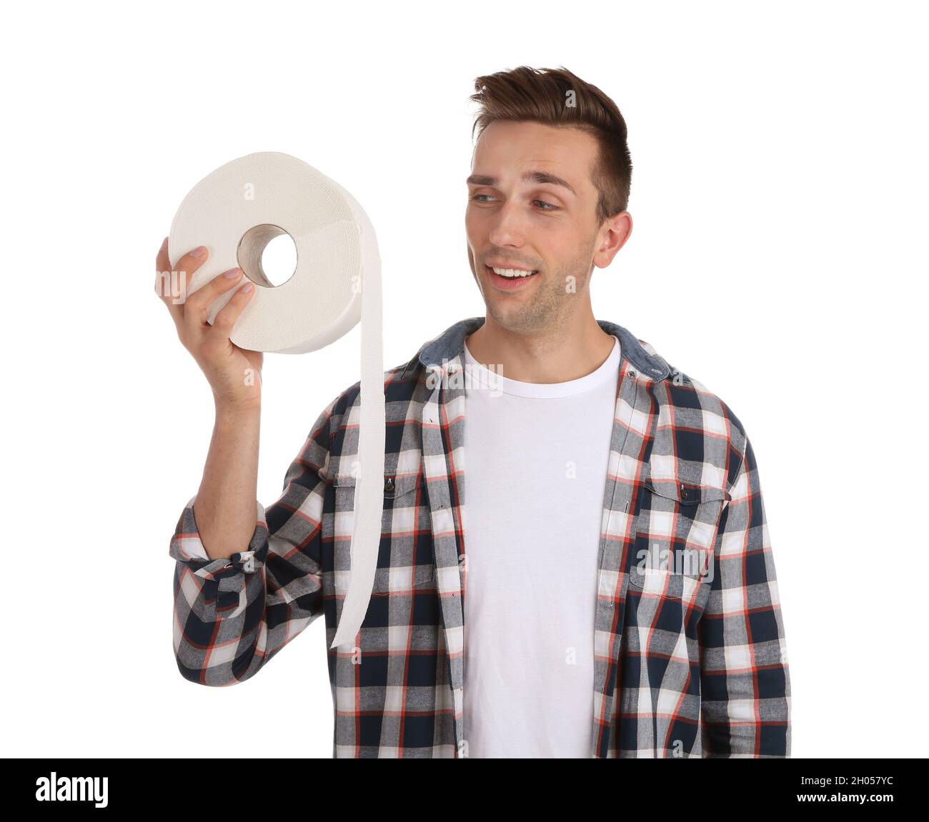 Young man holding toilet paper roll on white background Stock Photo - Alamy