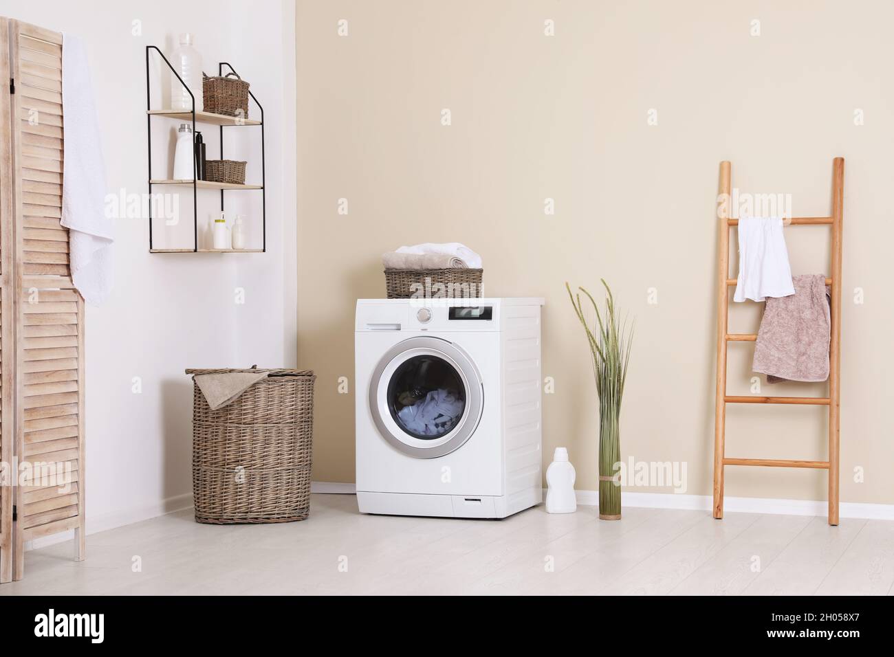 Laundry room interior with washing machine near wall Stock Photo - Alamy