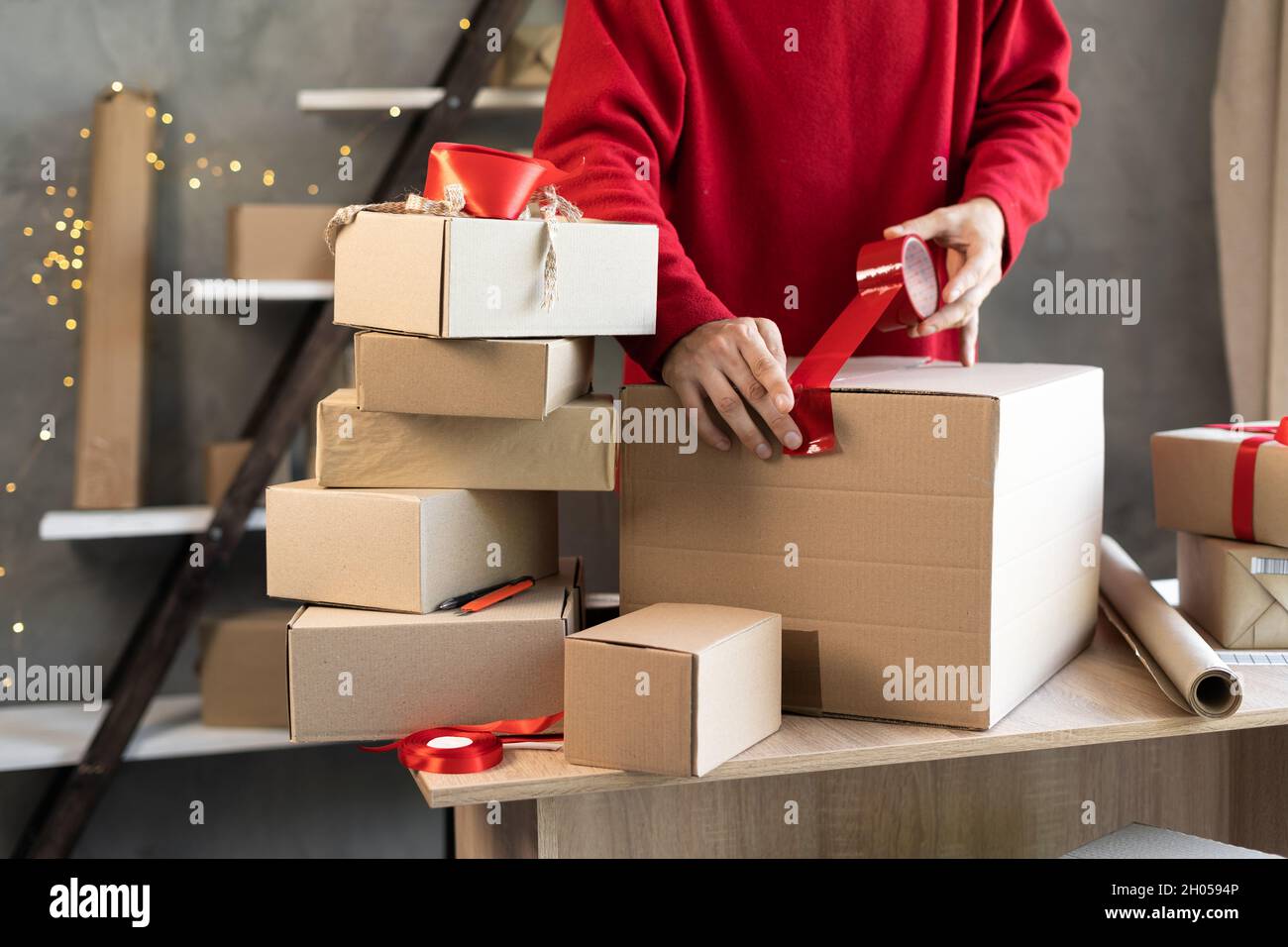 a man entrepreneur small business owner is packing goods at home in a ...