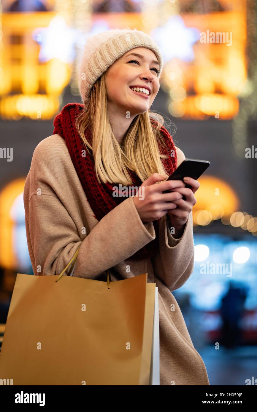 Shopper woman buying online on the smart phone at Christmas. People ...