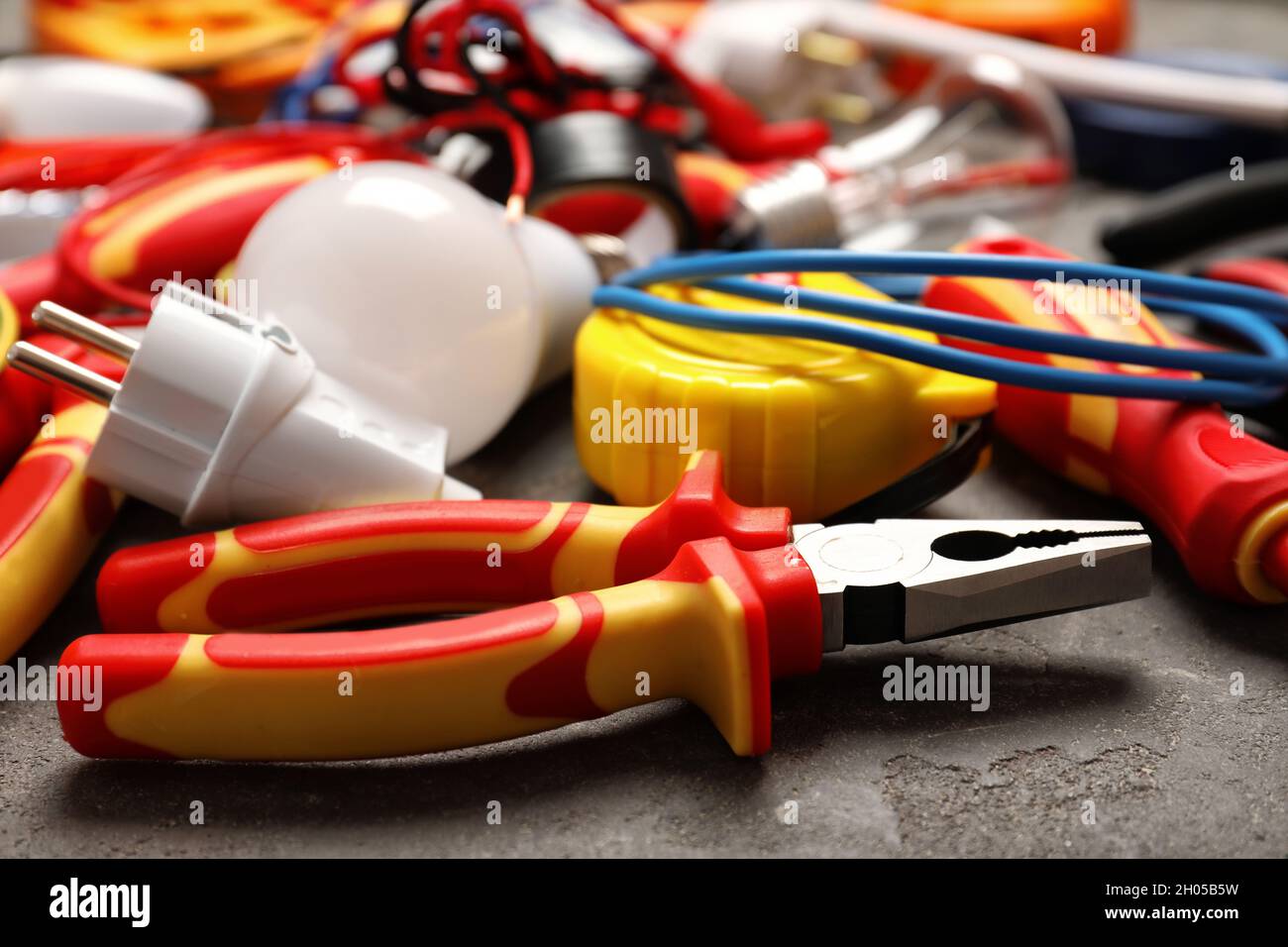 Set of electrician's tools on gray table Stock Photo - Alamy