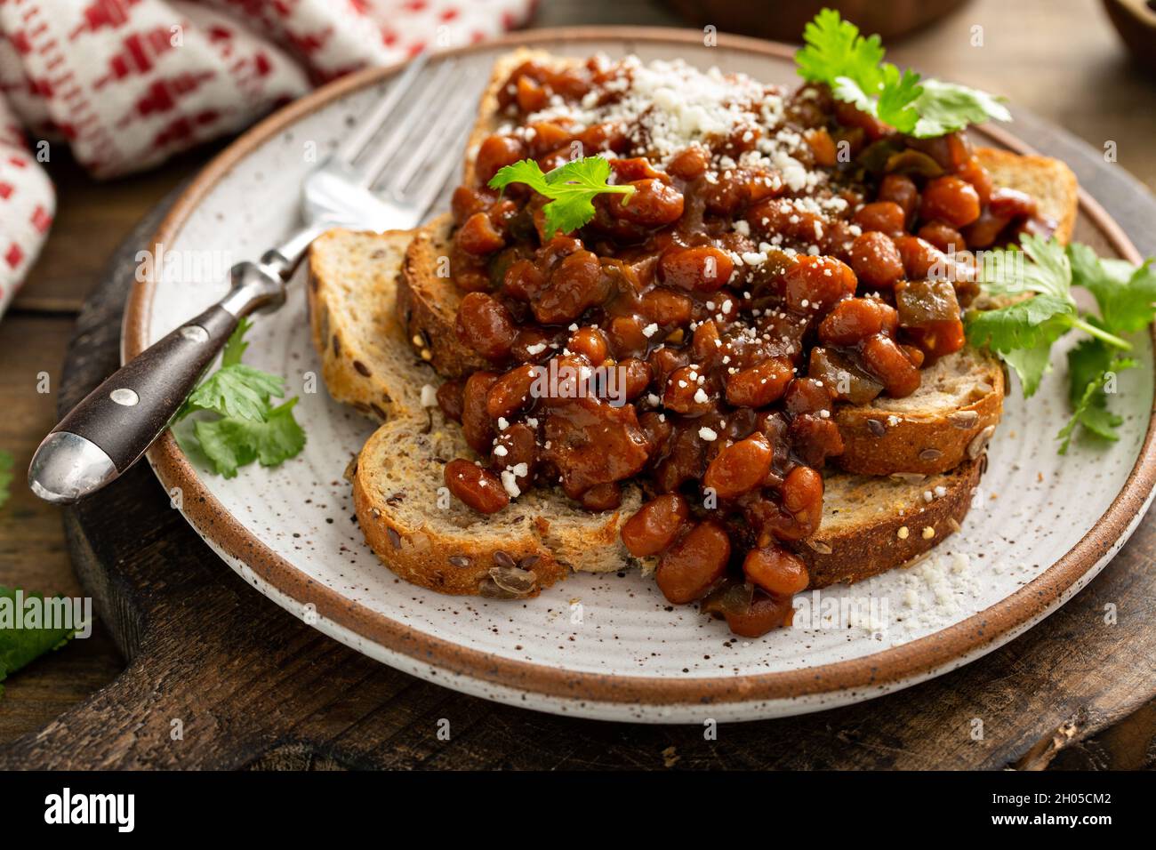 Baked beans with bacon on a toast Stock Photo - Alamy
