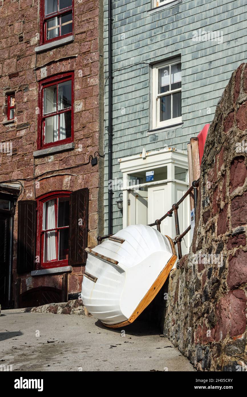 A boat lays against the waterfront railings in the quaint, traditional ...