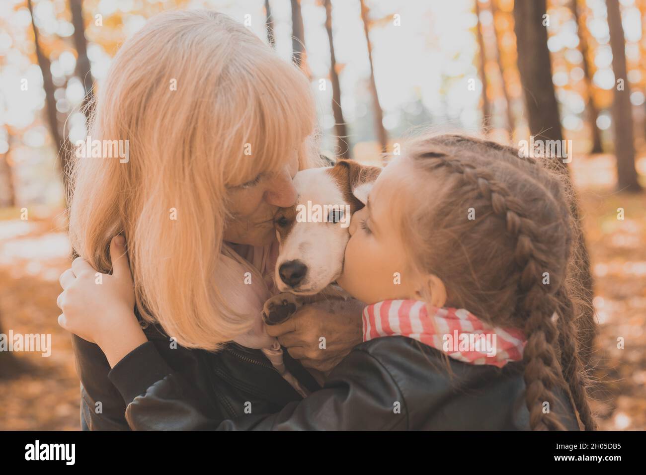 Grandmother with granddaughter in autumn park, girl hugging grandmother ...