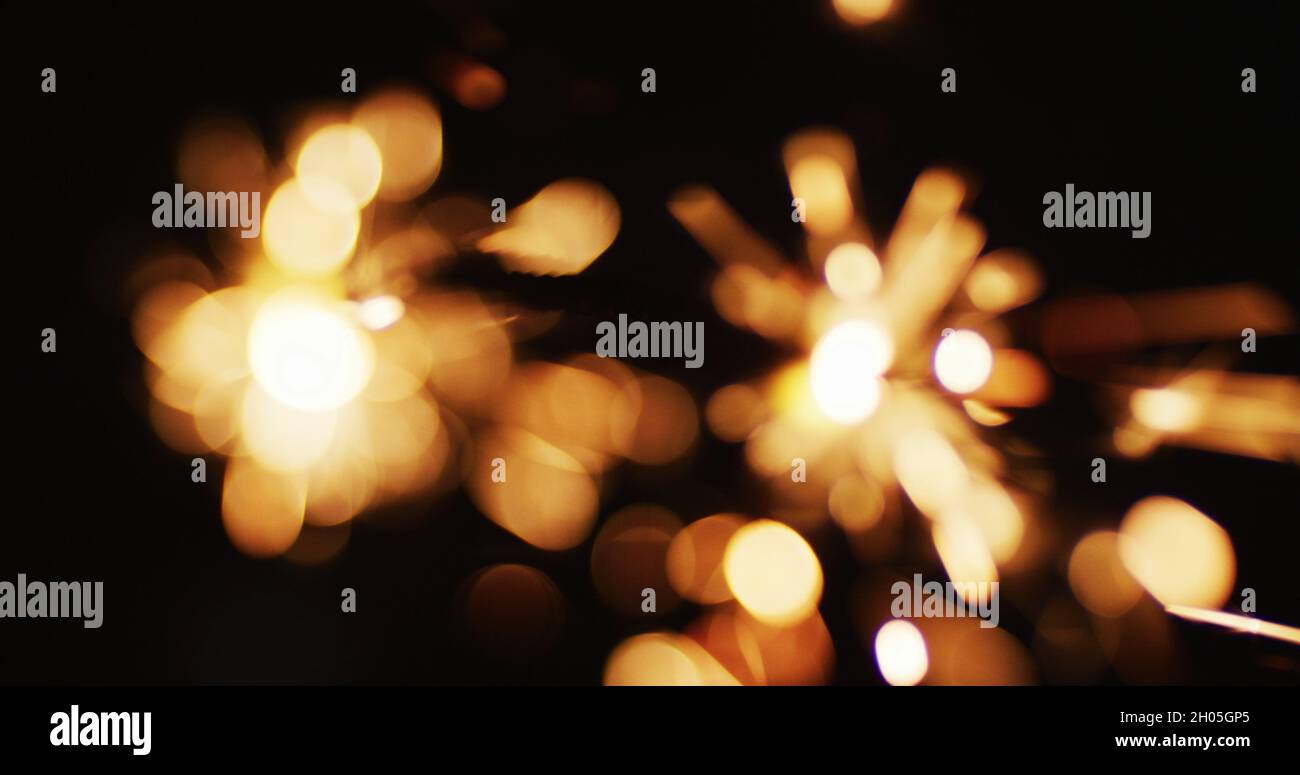 Two out of focus party sparklers sparkling on black background Stock ...