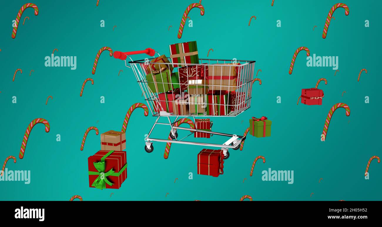 Image of falling christmas gifts and candy canes over shopping cart ...