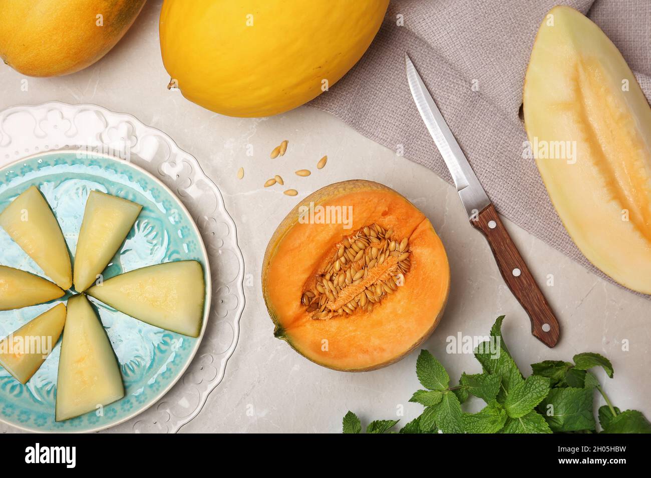 Flat lay composition with cut fresh tasty melons on table Stock Photo ...