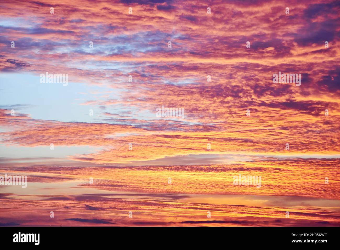 Bright orange and pink sunset with massive sharp cumulus clouds ...
