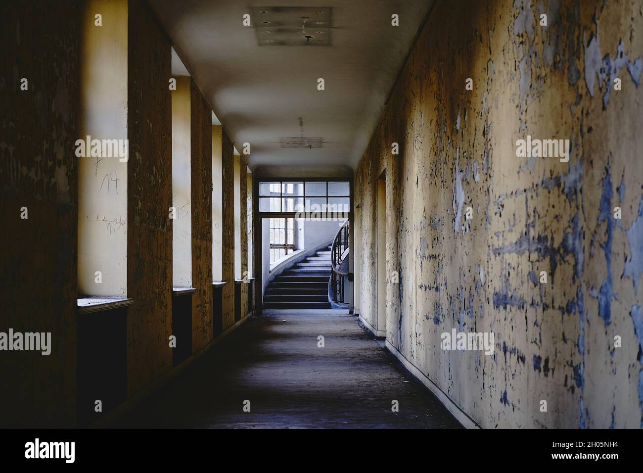 Corridor with damaged dirty walls leading to the stairs Stock Photo - Alamy