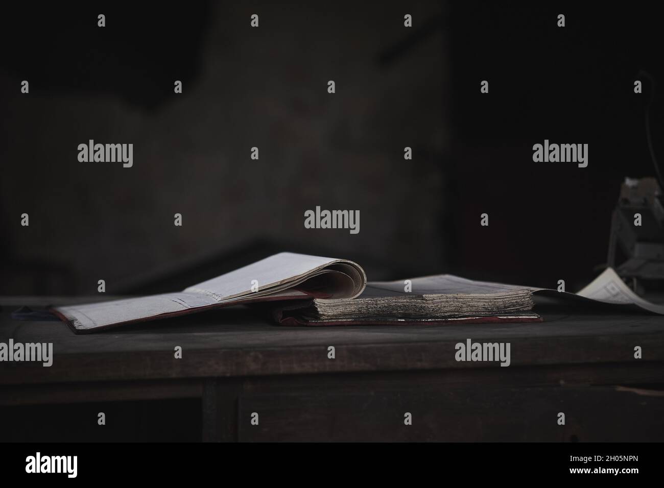 Open book lying on a table on a dark background Stock Photo - Alamy