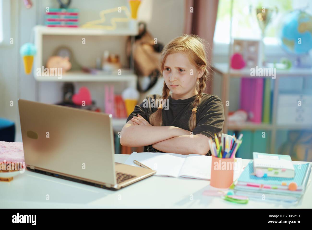 modern pupil in grey shirt with laptop and workbook homeschooling at ...