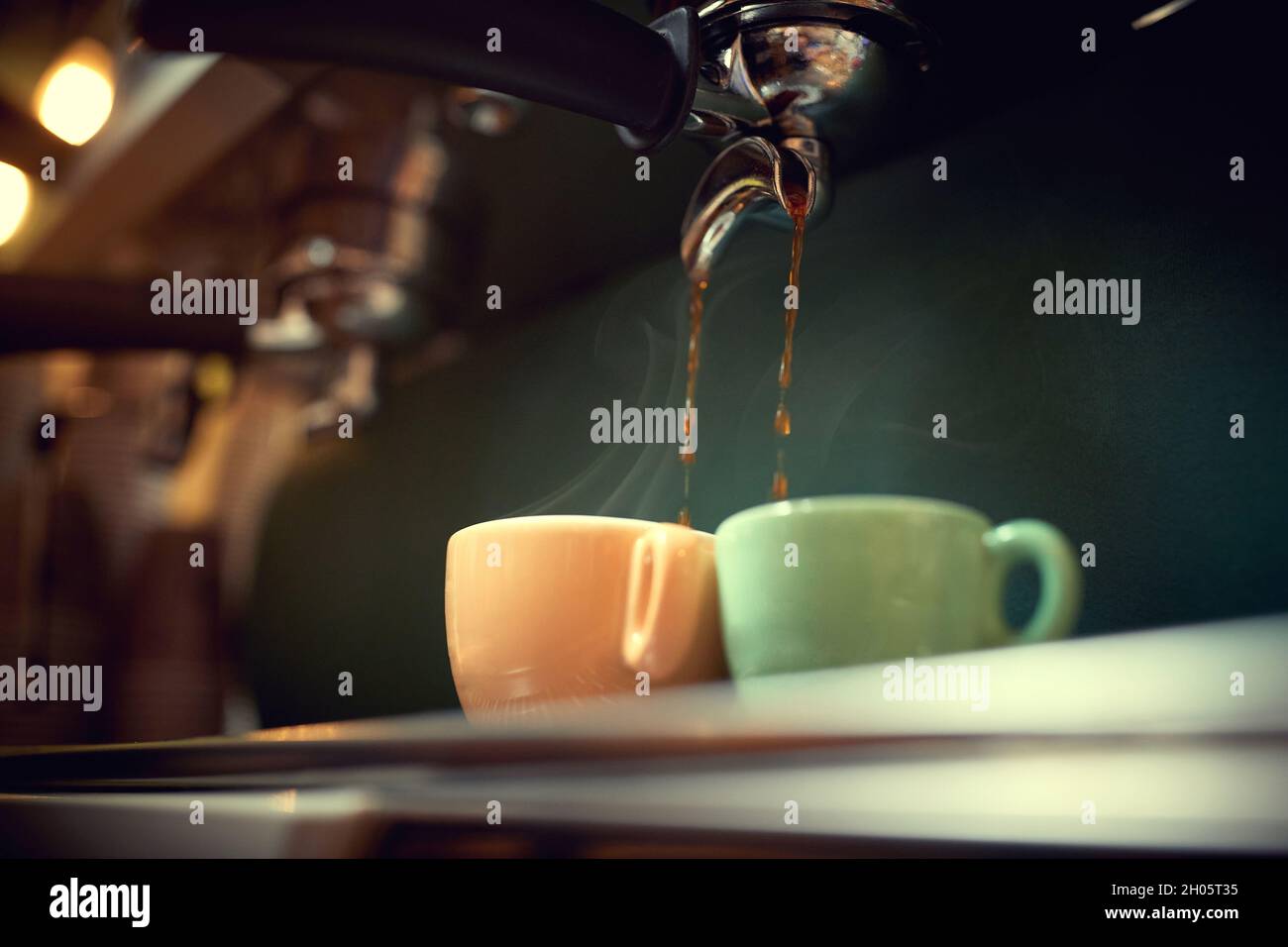Close up of a cups filling with coffee on coffee maker Stock Photo - Alamy