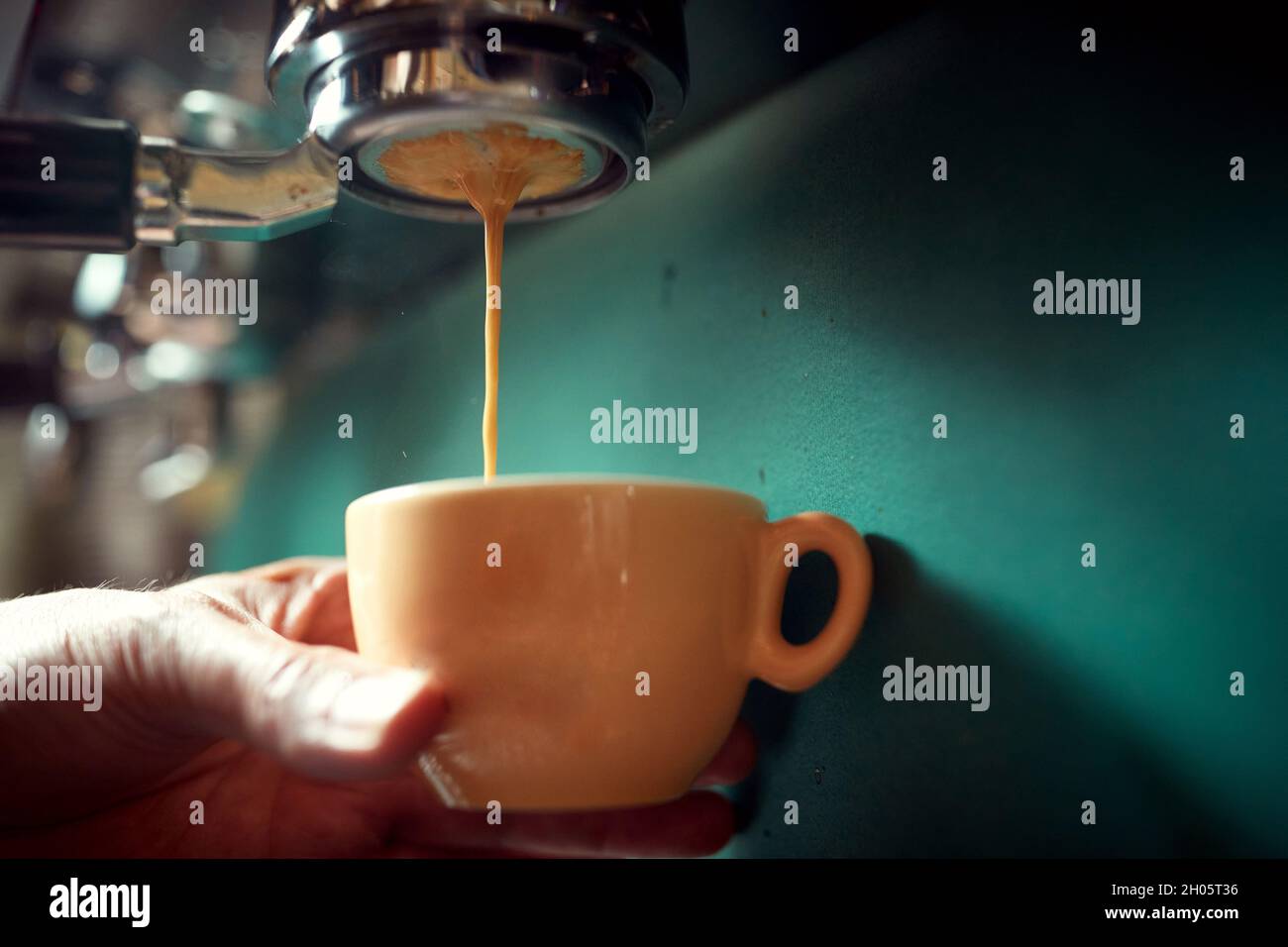 Close up of a worker making coffee on espresso maker Stock Photo - Alamy