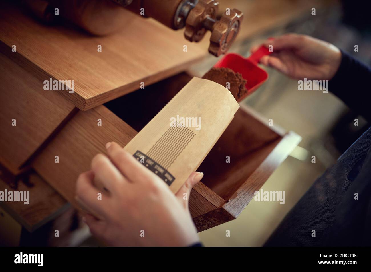 Barista measuring fresh grinded coffee for the customer Stock Photo - Alamy