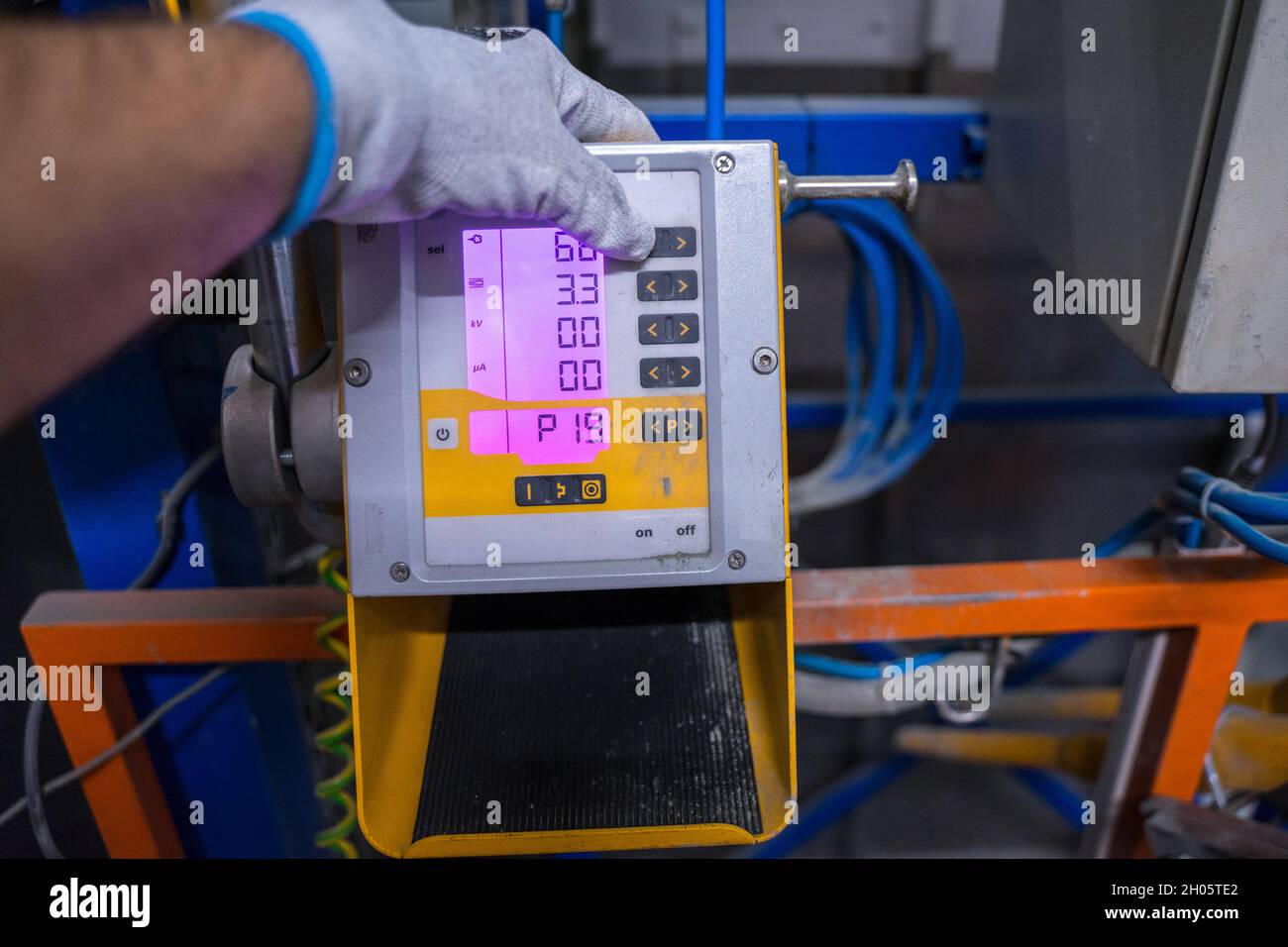 A powder painter operates a device for manual powder application Stock ...