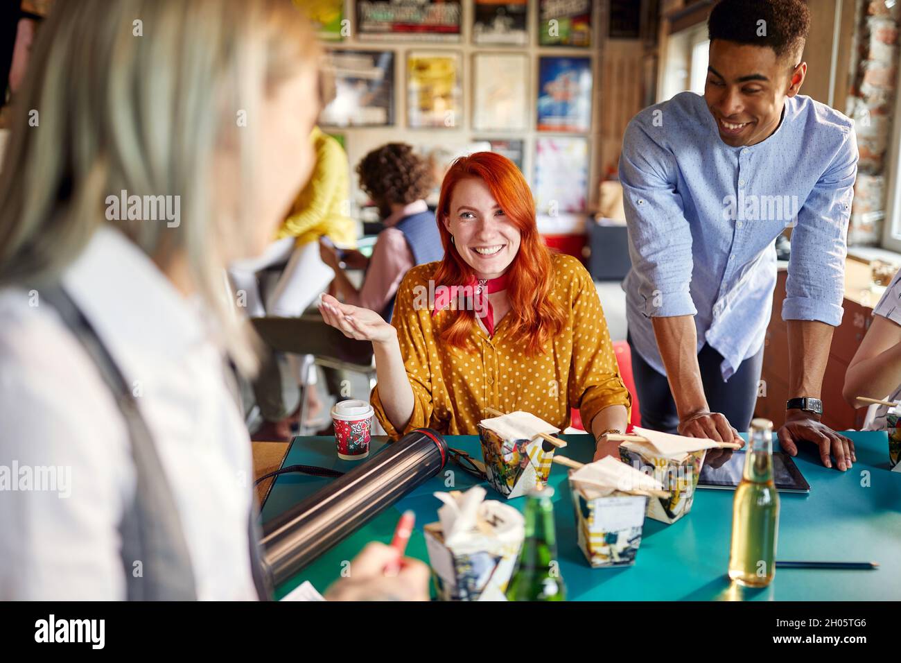 Group of young coworkers eating together on the break Stock Photo - Alamy