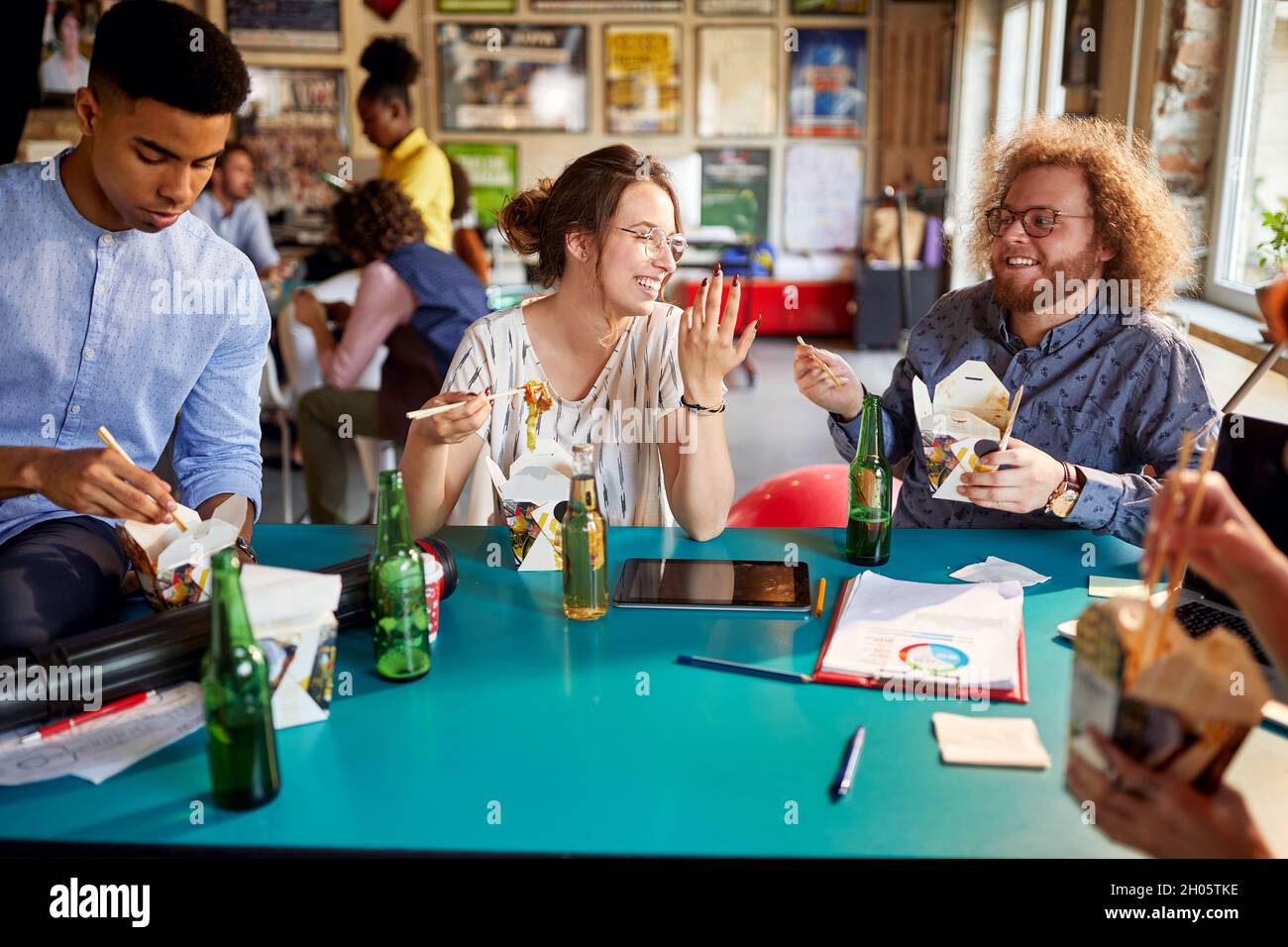 group of young adult people at work having lunch break, eating chinese ...